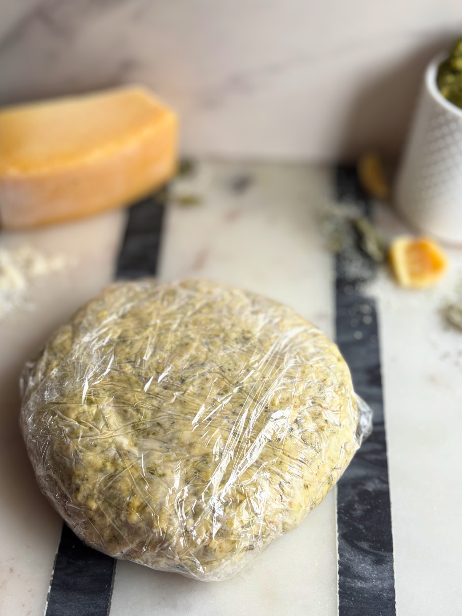 Sourdough pesto scone dough disc wrapped in plastic and ready to chill ...